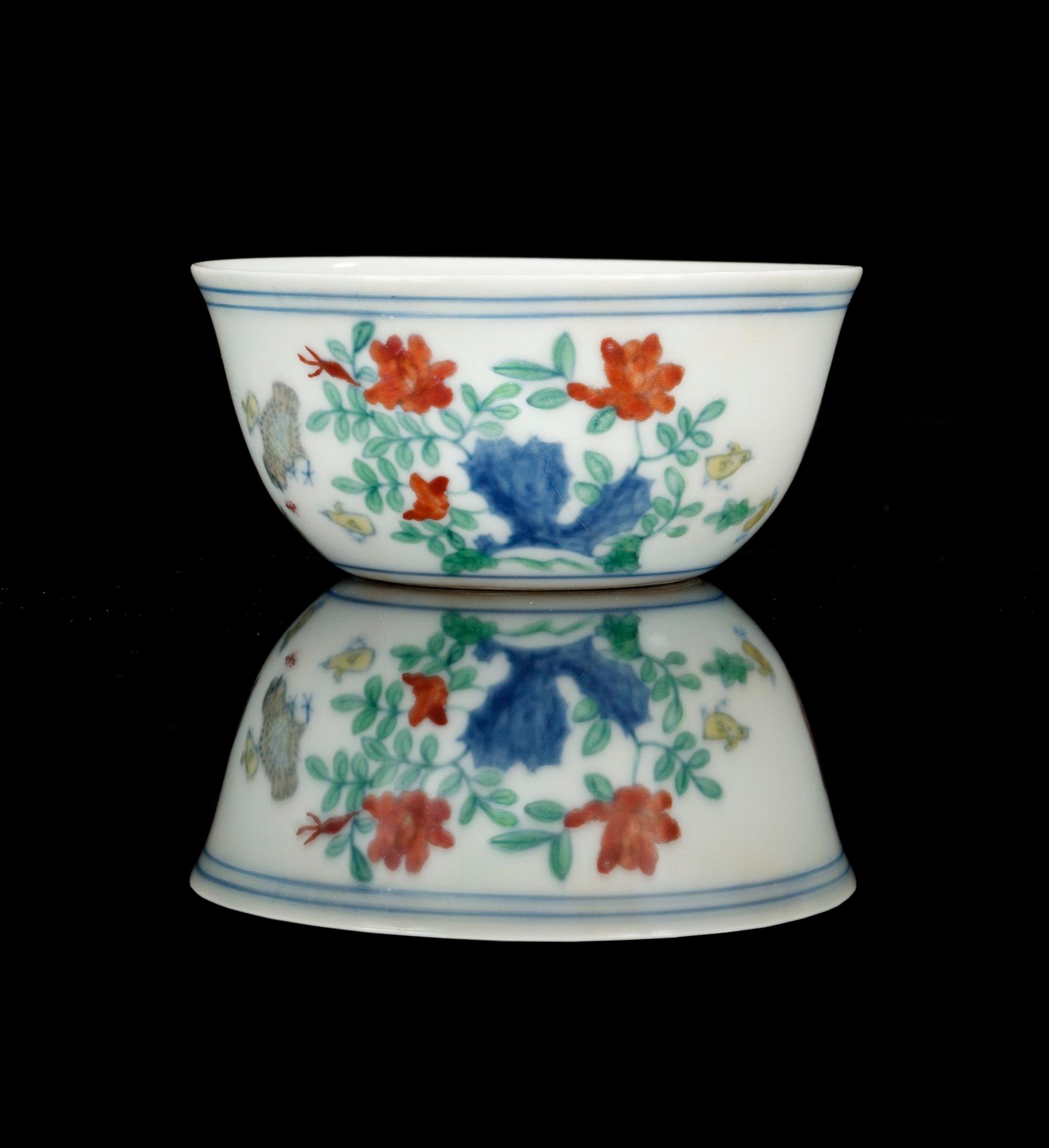 A rare doucai 'Chicken' cup, Ming dynasty, six character mark and ...