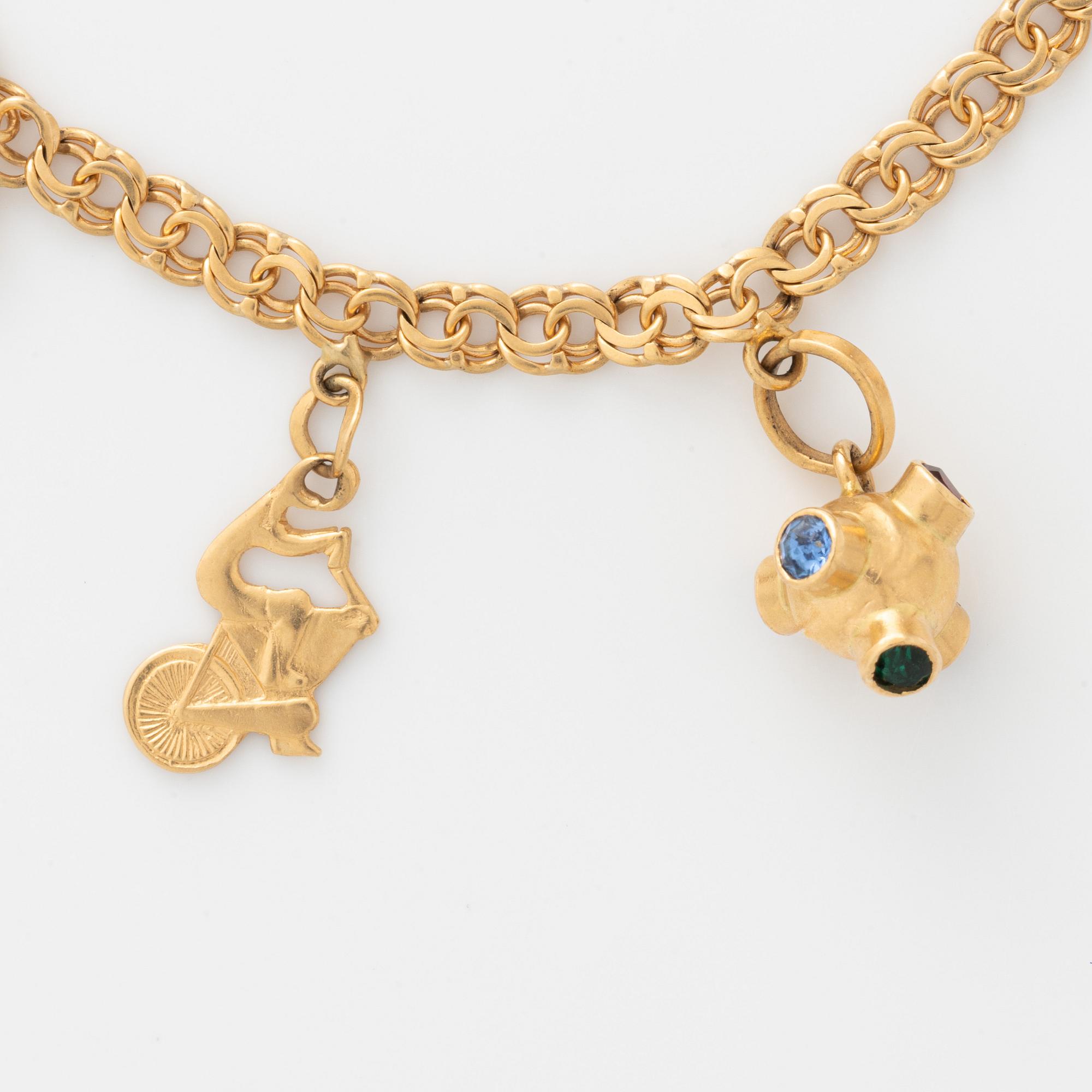 Armband med berlocker 18K guld. - Bukowskis