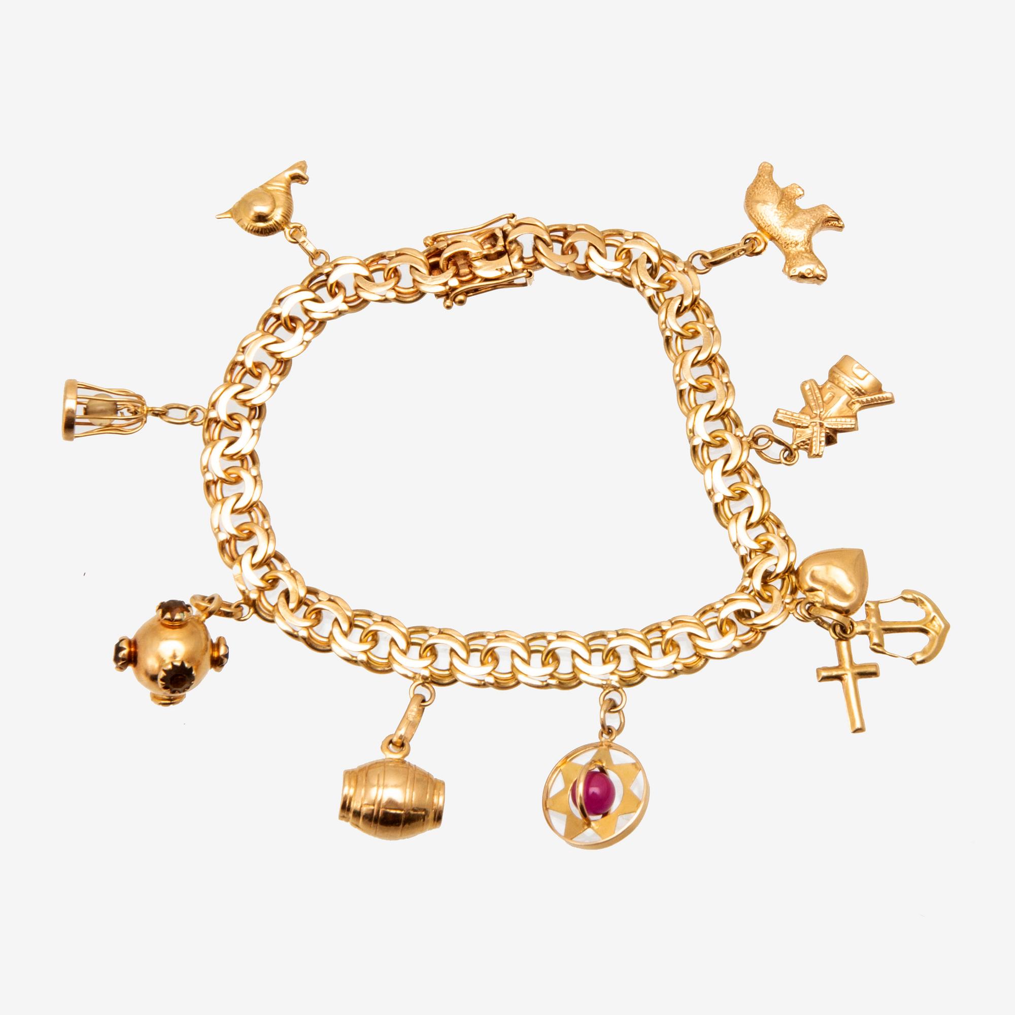 Armband Bismarck 18K guld med berlocker. - Bukowskis