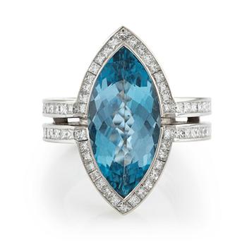 An 18K white gold Gaudy ring set with a faceted aquamarine and princess ...