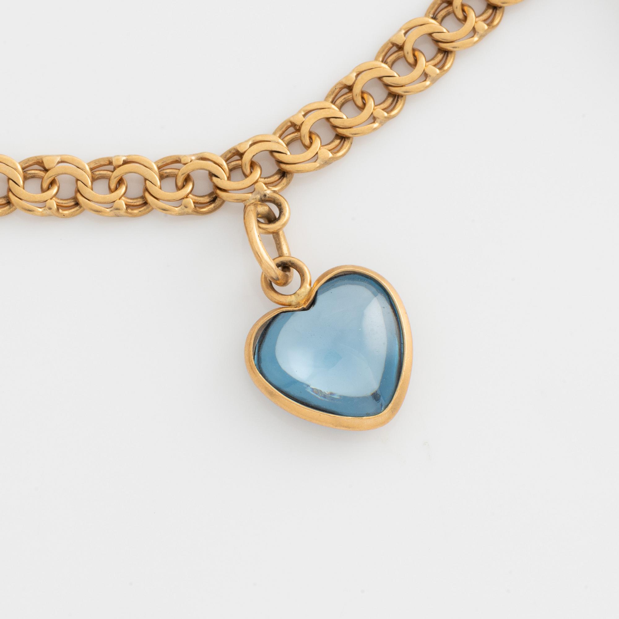 Armband med berlocker 18K guld. - Bukowskis