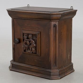A mid 20th Century wooden relief cupboard, according to provenance by ...