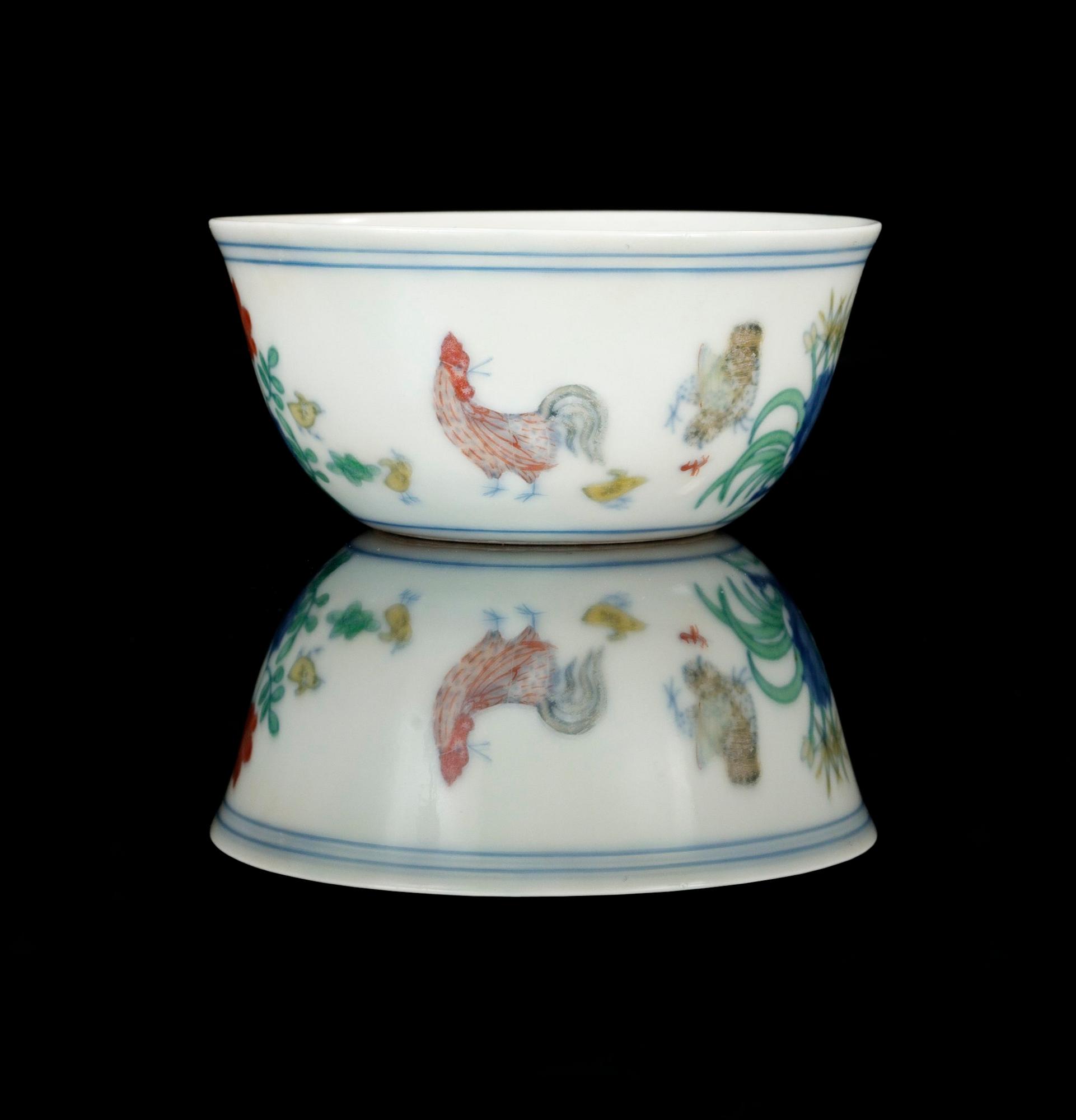 A rare doucai 'Chicken' cup, Ming dynasty, six character mark and ...
