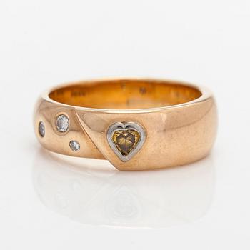 A 14K gold ring set with round brilliant-cut diamonds, and a heart ...