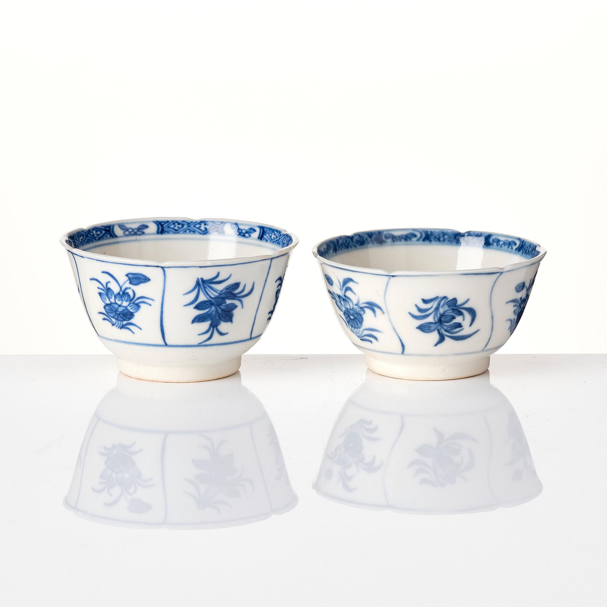 A pair of blue and white 'soft paste' cups with saucers, Qing dynasty ...