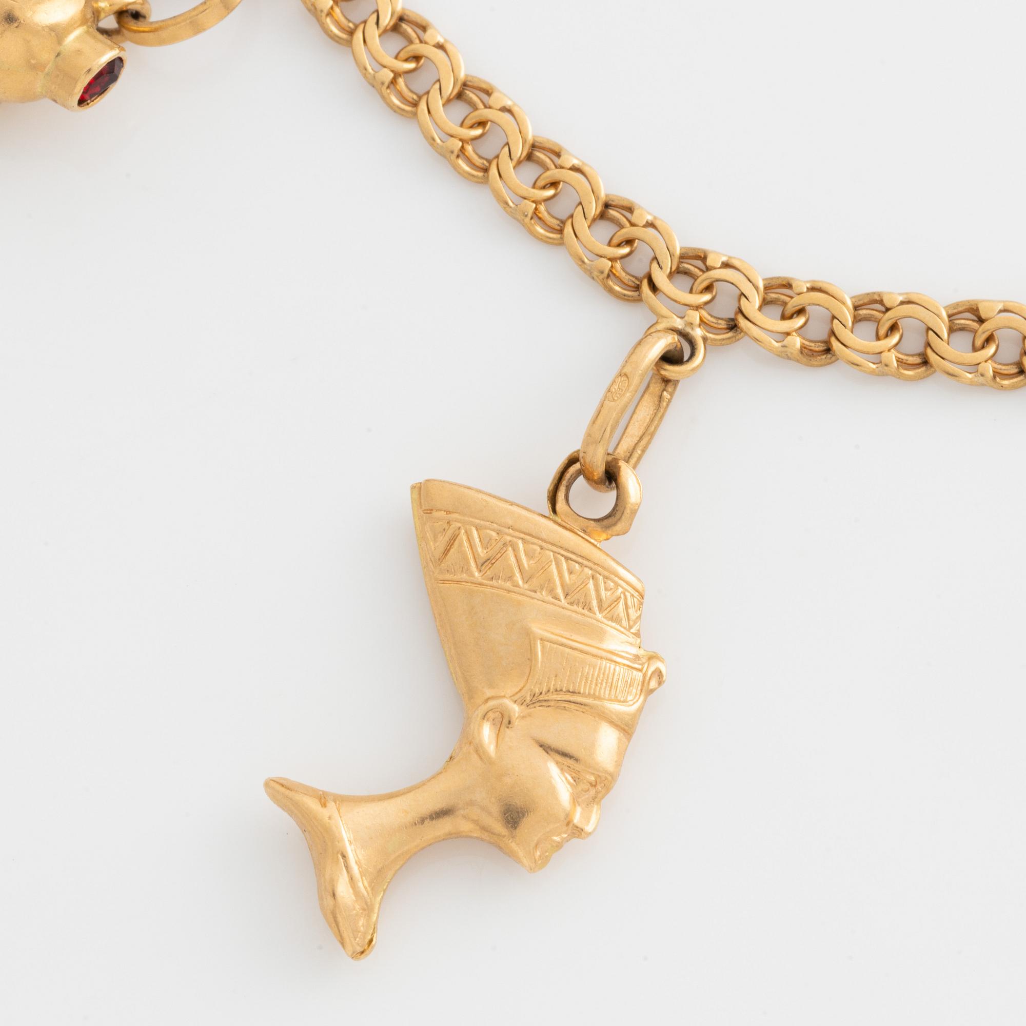 Armband med berlocker 18K guld. - Bukowskis